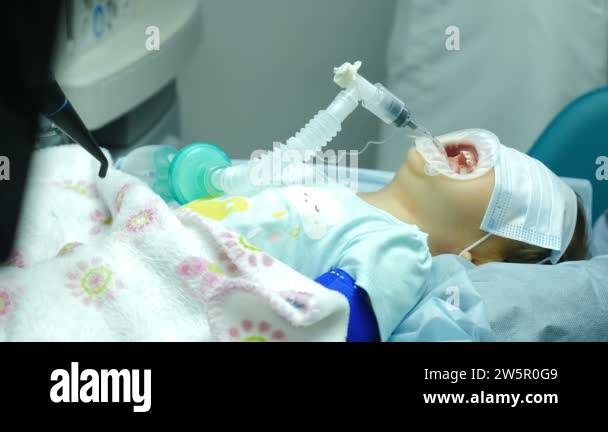 Dental treatment on child under generalanesthesia. Dentist doctor ...