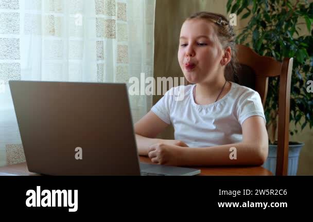 Speech training concept. Little girl uses a laptop to study at home ...