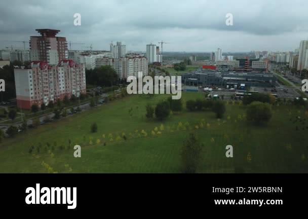Flight over the city block in cloudy weather. Multi-storey buildings ...