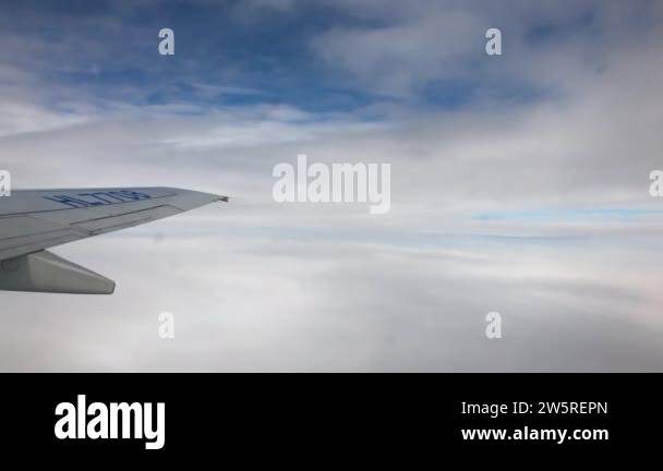 Looking through window aircraft during flight next to the wing with sky ...