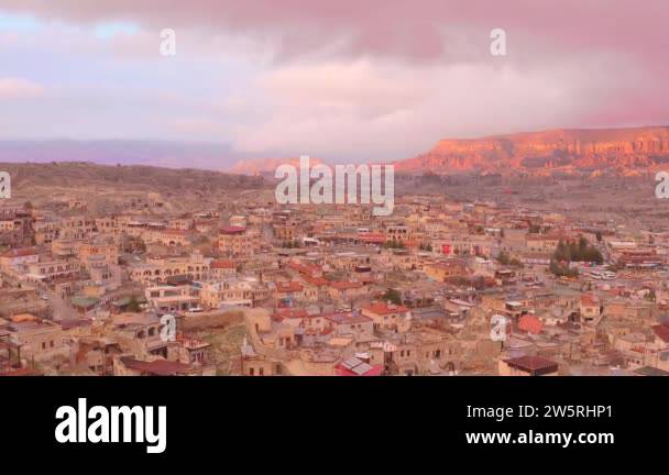 Ancient stone city on background of mountains at sunset. Action. Top ...