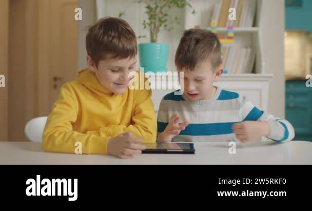 Two boys with autism using one tablet computer for education ...