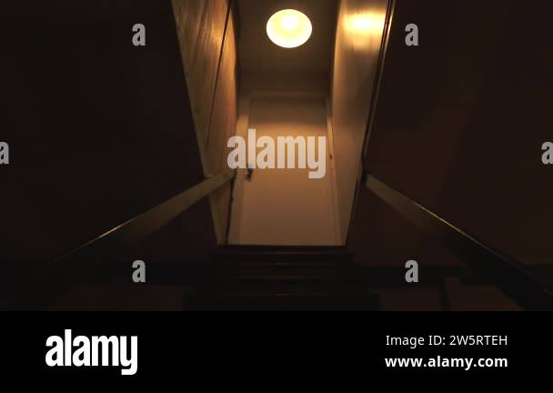 Evil person appears as door opens in dark room then walks down ...