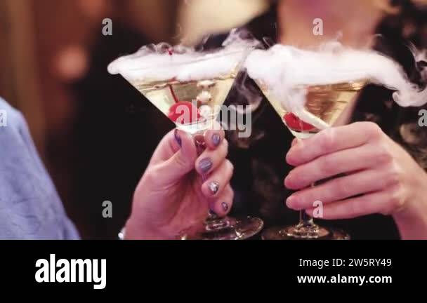 Glasses with alcoholic beverages in the pyramid, filling and pouring ...