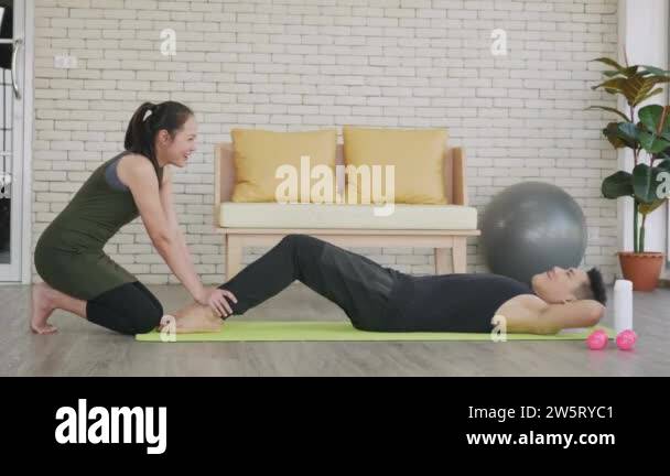 Happy Asian family couple husband and wife healthy trainer workout home ...