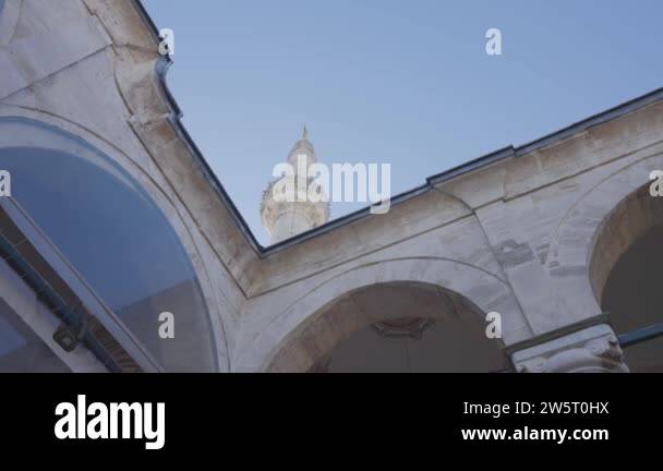 Tower and arches of mosque on background of blue sky. Action. Bottom ...