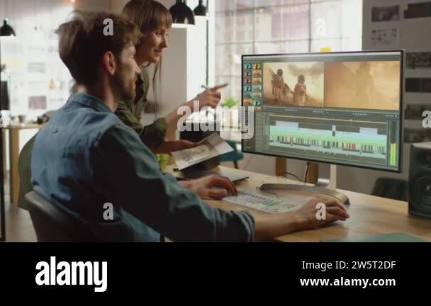 Beautiful Female Art Director Consults Handsome Video Editor Colleague ...