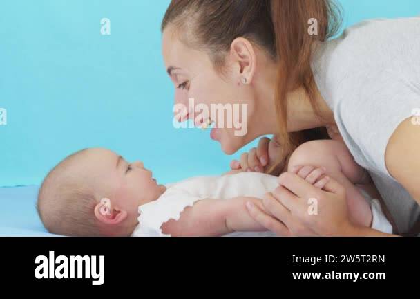 Tender loving mother kissing bonding with cute small baby girl daughter ...