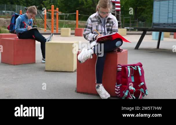 School children studying and making teamwork together on schoolyard. 4K ...