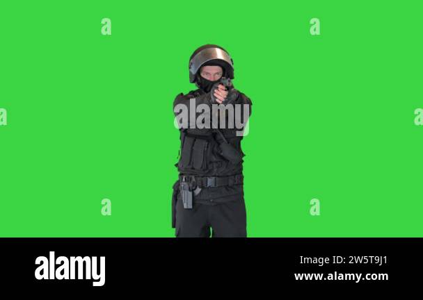 Police tactical unit aiming with a hand gun on a Green Screen, Chroma ...