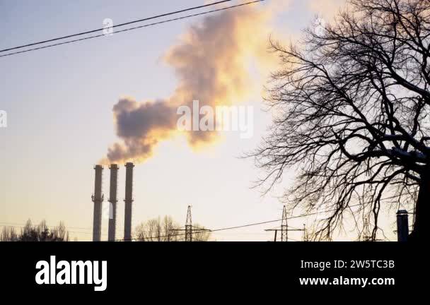 Thick smoke coming out of the pipes. Dirty smoke from industrial pipe ...