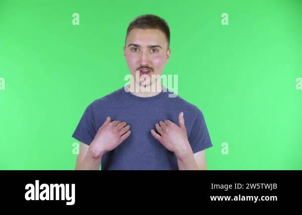 Portrait of a young man pointing herself, say who me no thanks i do not ...