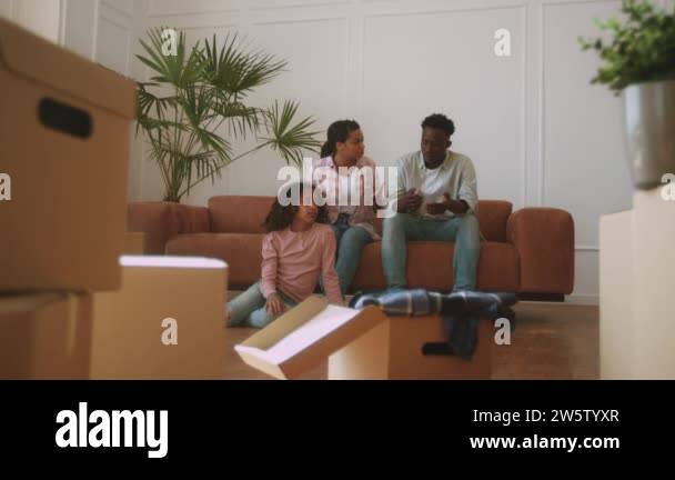 Young nervous african american parents quarreling in new home, sad ...