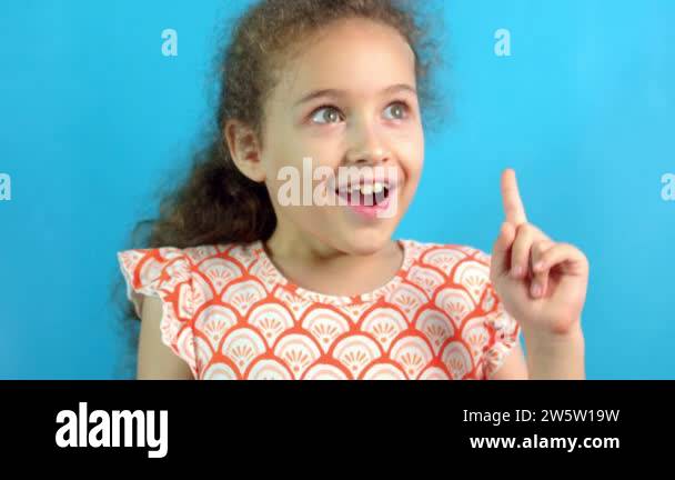 Smiling happy little girl showing eureka gesture. Portrait of young ...