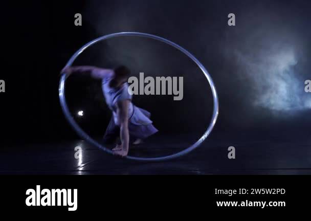 Circus artist shows concentration and balance while spinning on a Cyr ...