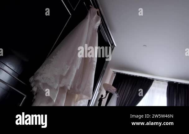 Delicate Wedding Dress Hangs On A Beam Under The Ceiling In The Wedding ...