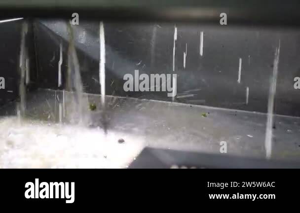 Wiine production in private small winery. Red grape juice dripping from ...