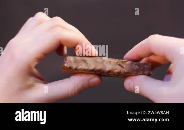 Hands breaking a chocolate bar. Chocolate bar Stock Video Footage - Alamy