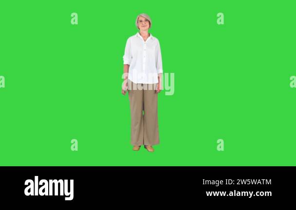 Aged Woman in White Shirt Standing Doing Nothing on a Green Screen ...