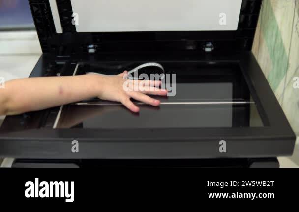 Hand scanning process. The scanner in operation scans a childs hand ...