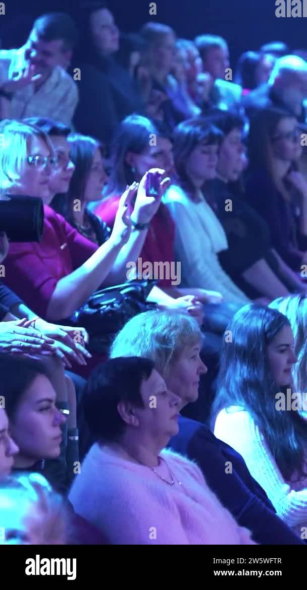 People viewers in a TV studio while recording a TV show. Vertical video ...