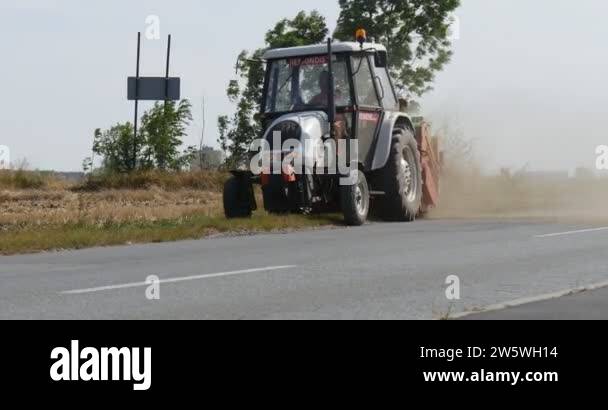 Man is Driving The Tractor With Trailer And Plow is Driven by Road ...