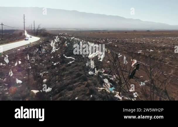 Plastic pollution trash on countryside field with different kinds of ...