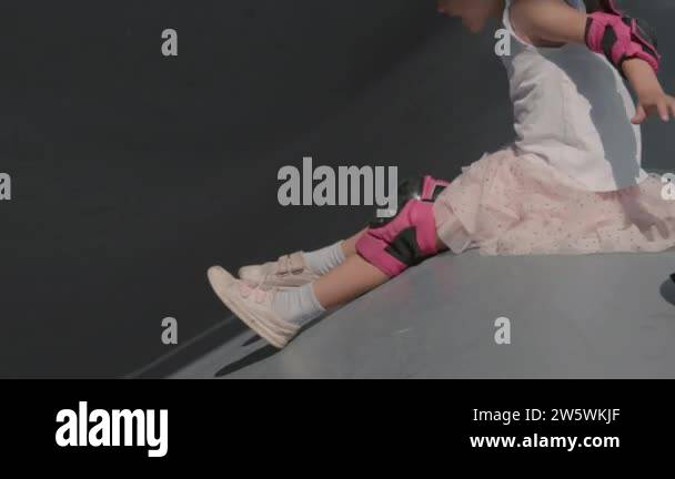 Cheerful teenage Caucasian girl wearing elbow and knee pads having fun ...