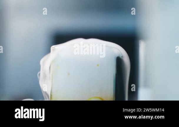 Details closeup boiling yellow substance from the flask in the ...