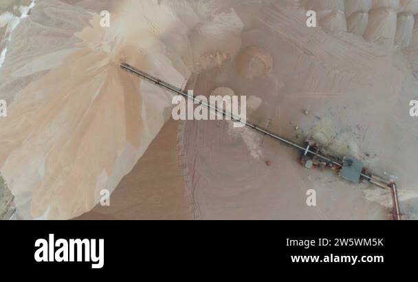 Salt piles, aerial view of industrial quarries, conveyor in salt pits ...