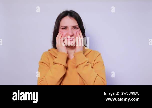 The woman holds her hands on the face - pain in sinuses, sinusitis ...