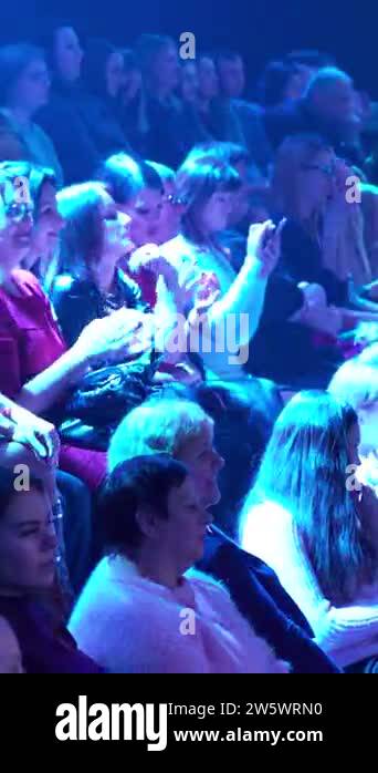 People viewers in a TV studio while recording a TV show. Vertical video ...