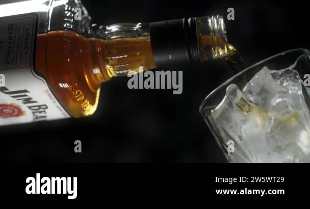WARSAW, POLAND - SEPTEMBER 10, 2021: Jim Beam is being poured in slow ...