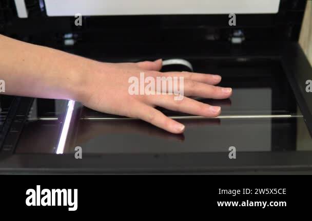 Hand scanning process. Scanner in operation scans a human hand with the ...
