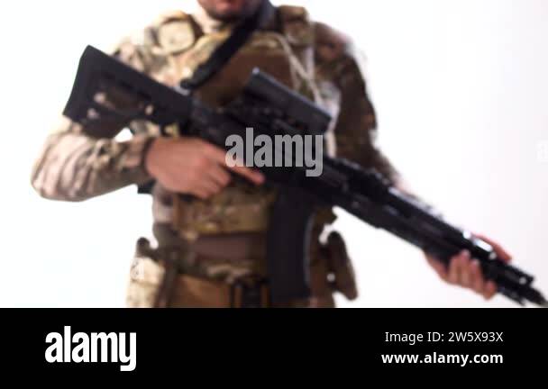 Soldier in modern military outfit and body armor with an assault rifle ...