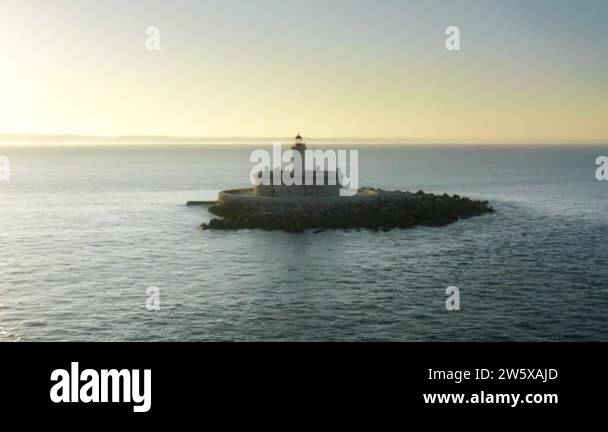 A prominent landmark of the Forte do Bugio lighthouse set offshore ...