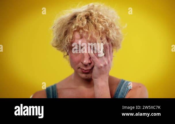 Headshot portrait of androgynous queer man touching face looking at ...
