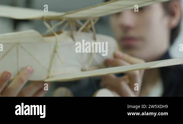 Teenage Boy is Holding The Model of Plane, Turning the Plane, Showing ...