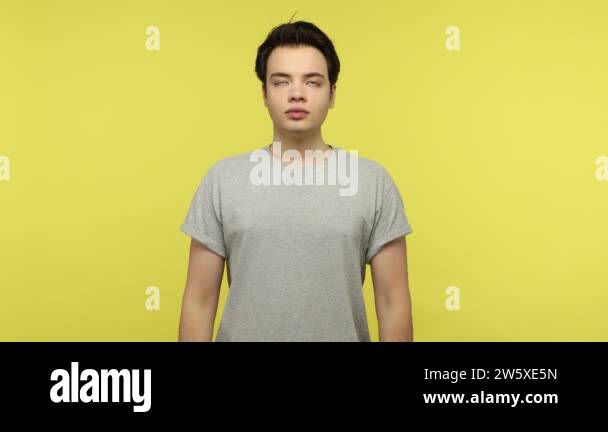 Young guy folding hands practicing mindful yoga, trying to calm down ...