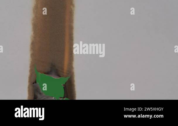 White paper is on fire. The sheet of paper burns, exposing the burnt ...