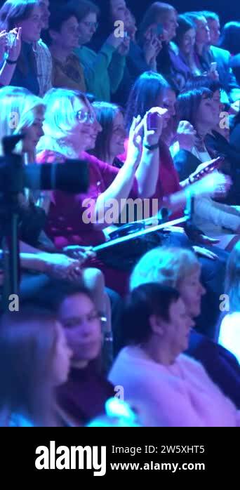 People viewers in a TV studio while recording a TV show. Vertical video ...