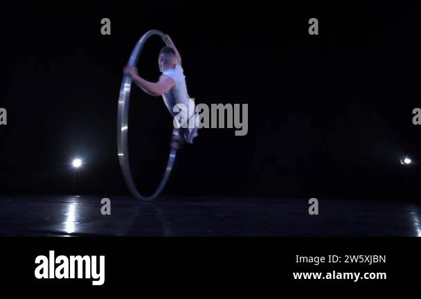 Circus artist shows concentration and balance while spinning on a Cyr ...