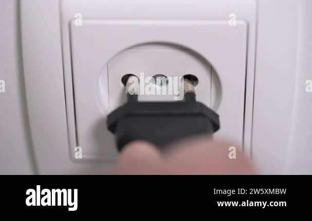 4K footage of power consumption, video of a man's hand plugging and ...