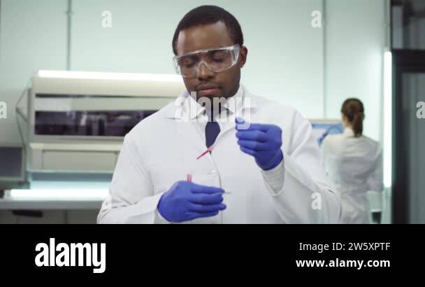 Close up of happy African American young man laboratory worker in ...