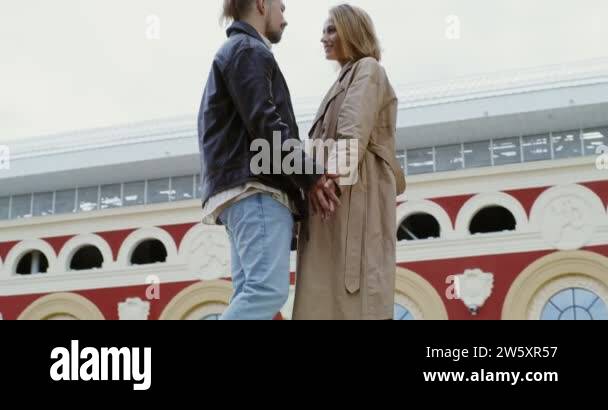 A young couple is walking along the parapet holding hands and stopping for kiss Stock Video ...