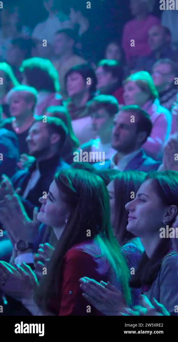 People viewers in a TV studio while recording a TV show. Vertical video ...