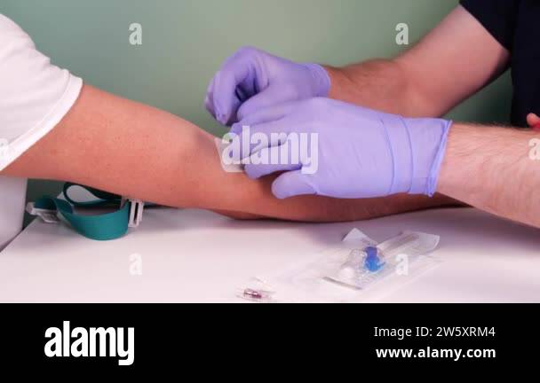Intravenous cannulation procedure. Nurse or doctor inserting cannula ...