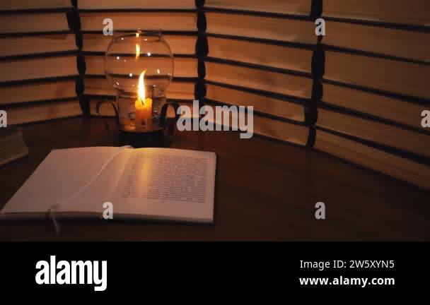 Open book and a burning candle. Reading a book by candlelight Stock ...
