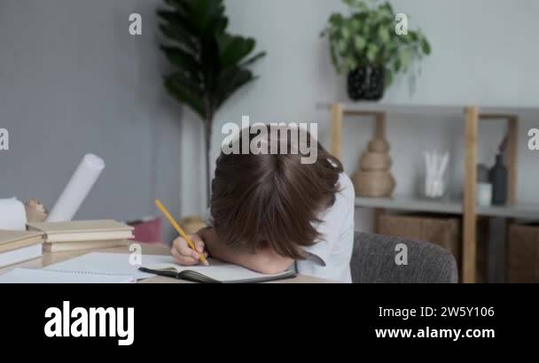 Exhausted school kid is tired from homework and learning and is lying ...