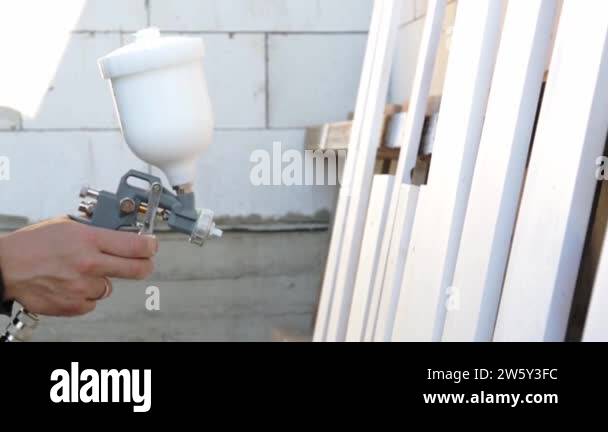 Close-up of a spray gun in a man hand. The process of painting the ...